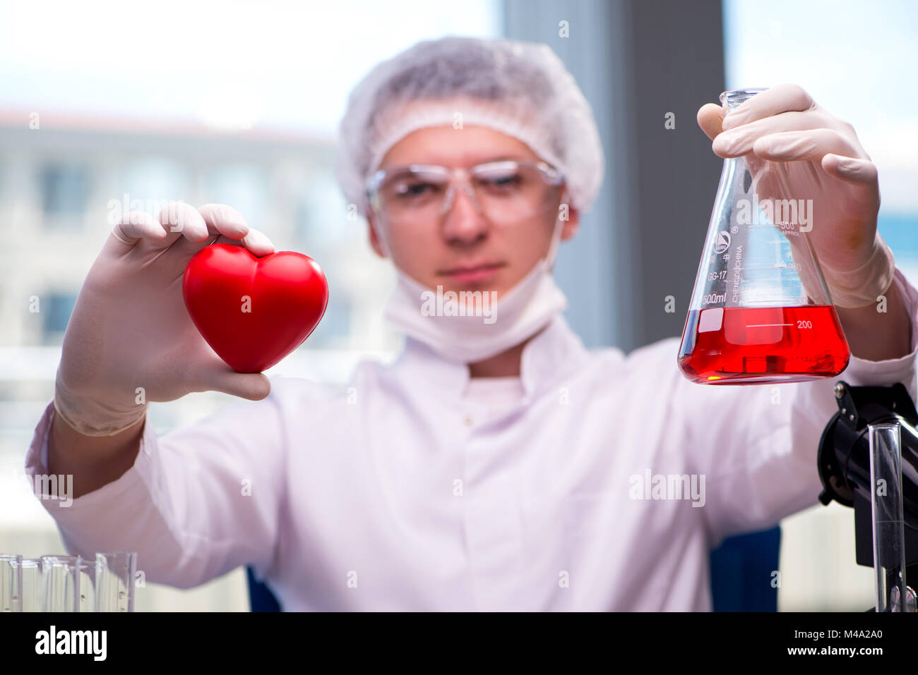 Doctor curing heart in medical concept Stock Photo - Alamy