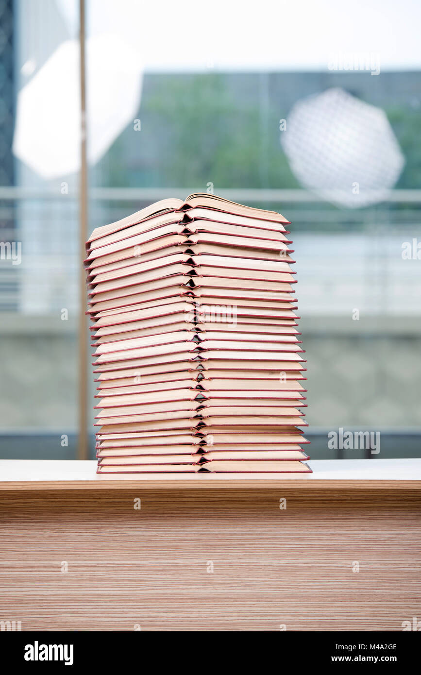 Stack of books arranged the office desk Stock Photo - Alamy