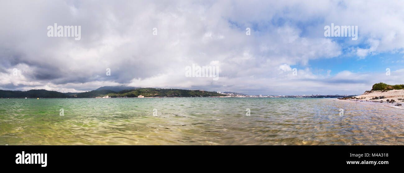 Wide panoramic view of Troia beach a beautiful day with clouds and blue ...