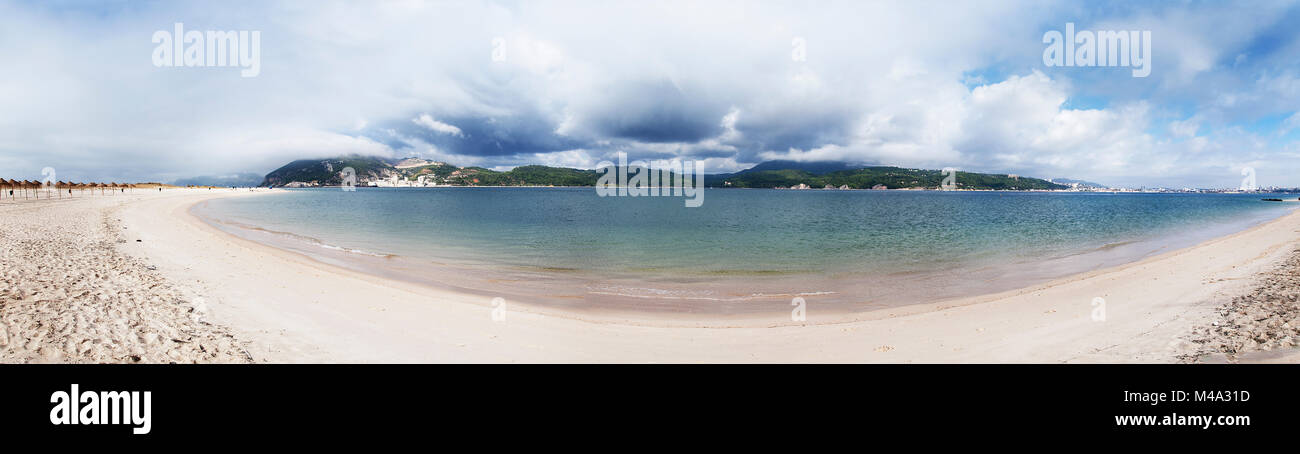 Wide panoramic view of Troia beach a beautiful day with clouds and blue ...