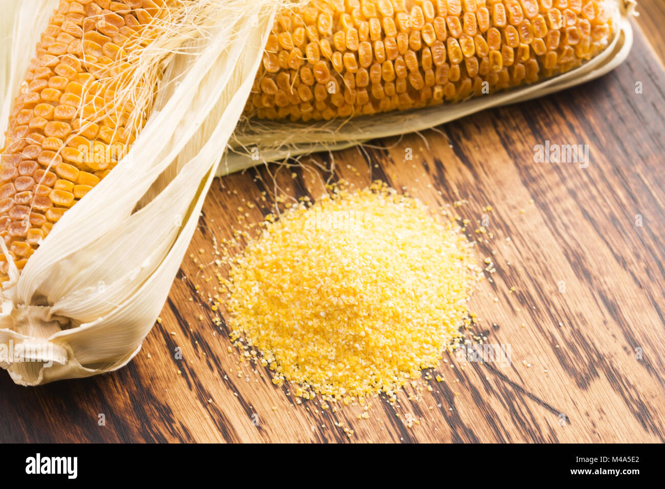Corn groats and seeds, corncobs on wooden rustic table Stock Photo - Alamy