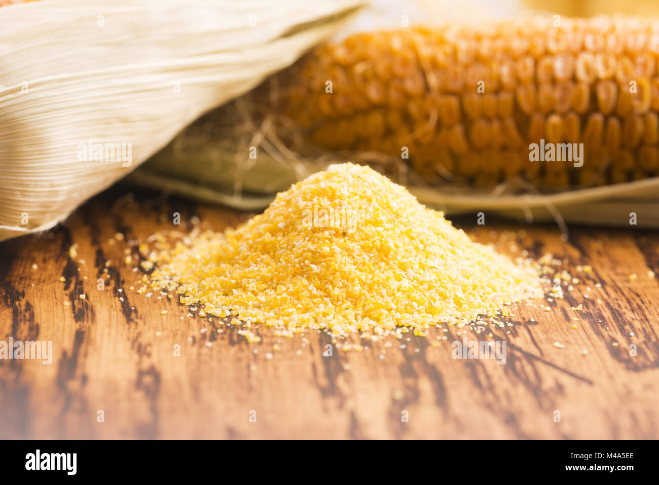 Corn groats and seeds, corncobs on wooden rustic table Stock Photo - Alamy