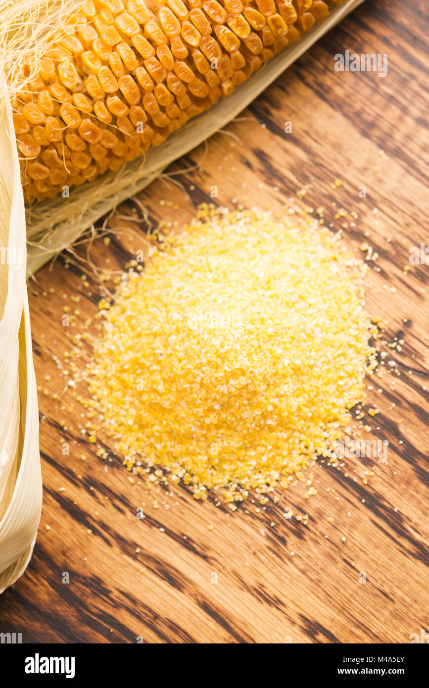 Corn groats and seeds, corncobs on wooden rustic table Stock Photo - Alamy