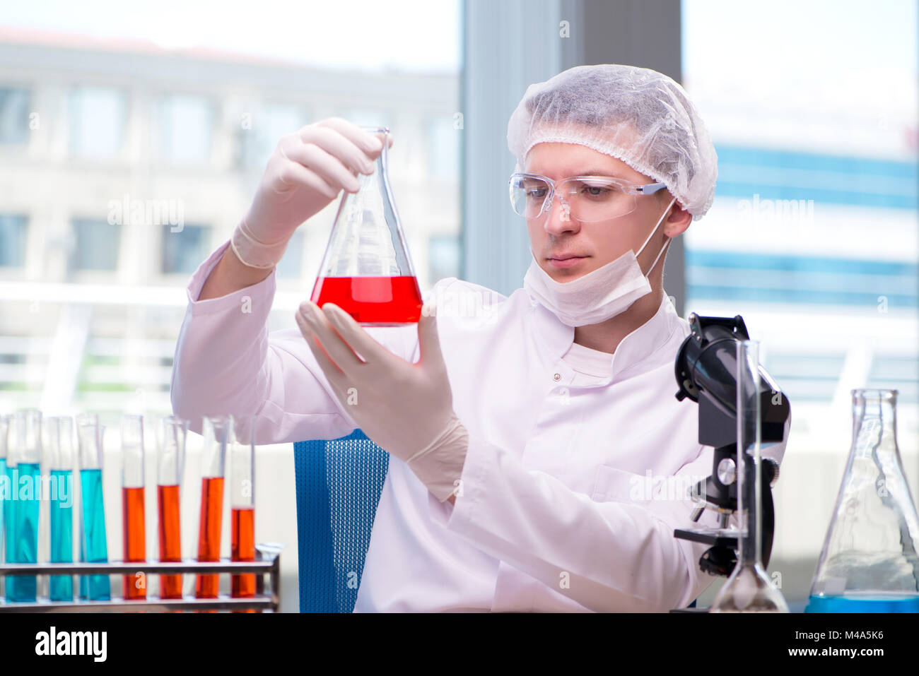 Man working in the chemical lab on science project Stock Photo - Alamy