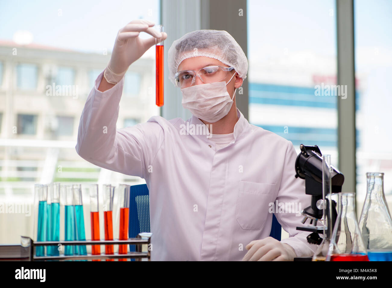 Man working in the chemical lab on science project Stock Photo - Alamy