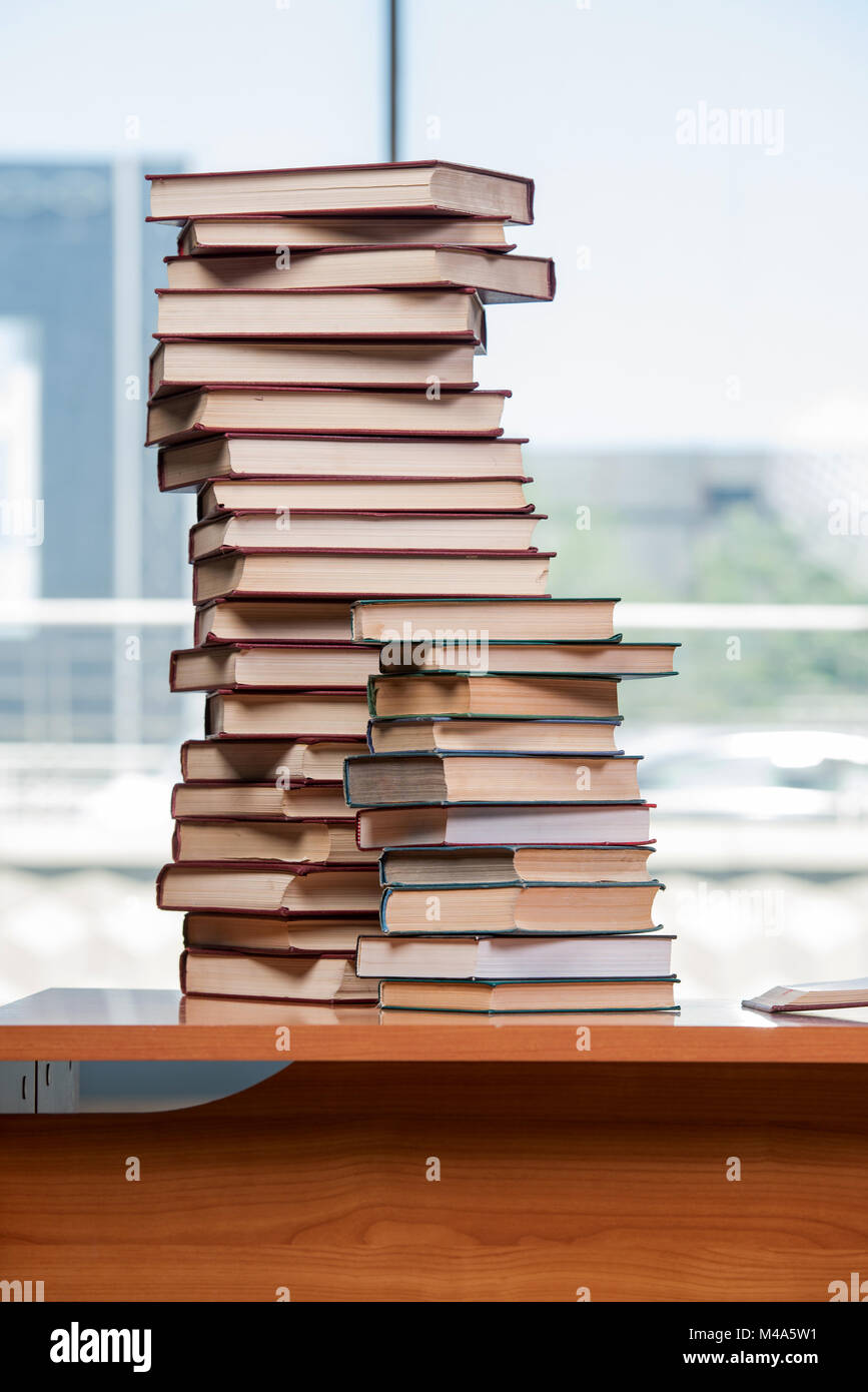 Stack of books on the desk in education concept Stock Photo - Alamy