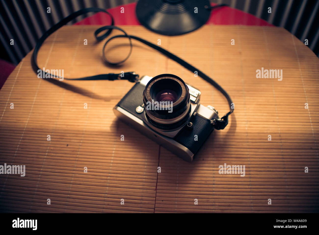 Vintage nikon camera with leather strap on japanese looking table Stock ...