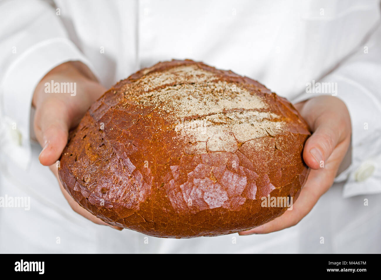 Man holding bread roll hi-res stock photography and images - Alamy