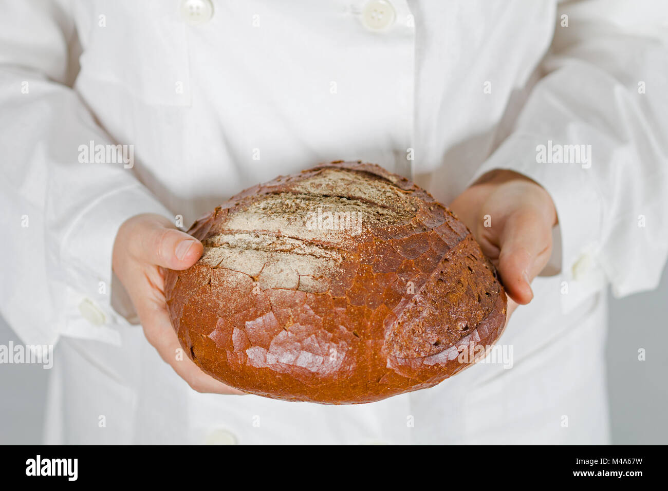 Man holding bread roll hi-res stock photography and images - Alamy