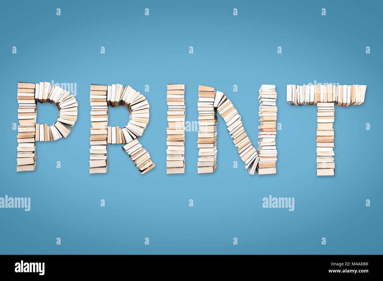 PRINT word formed from books, shot from above on light blue background ...