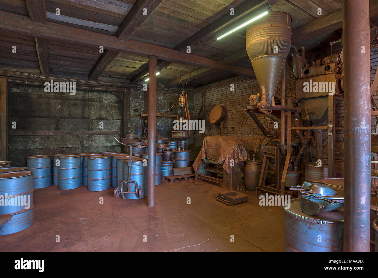 Production room for bronze powder with barrels and machines in a ...