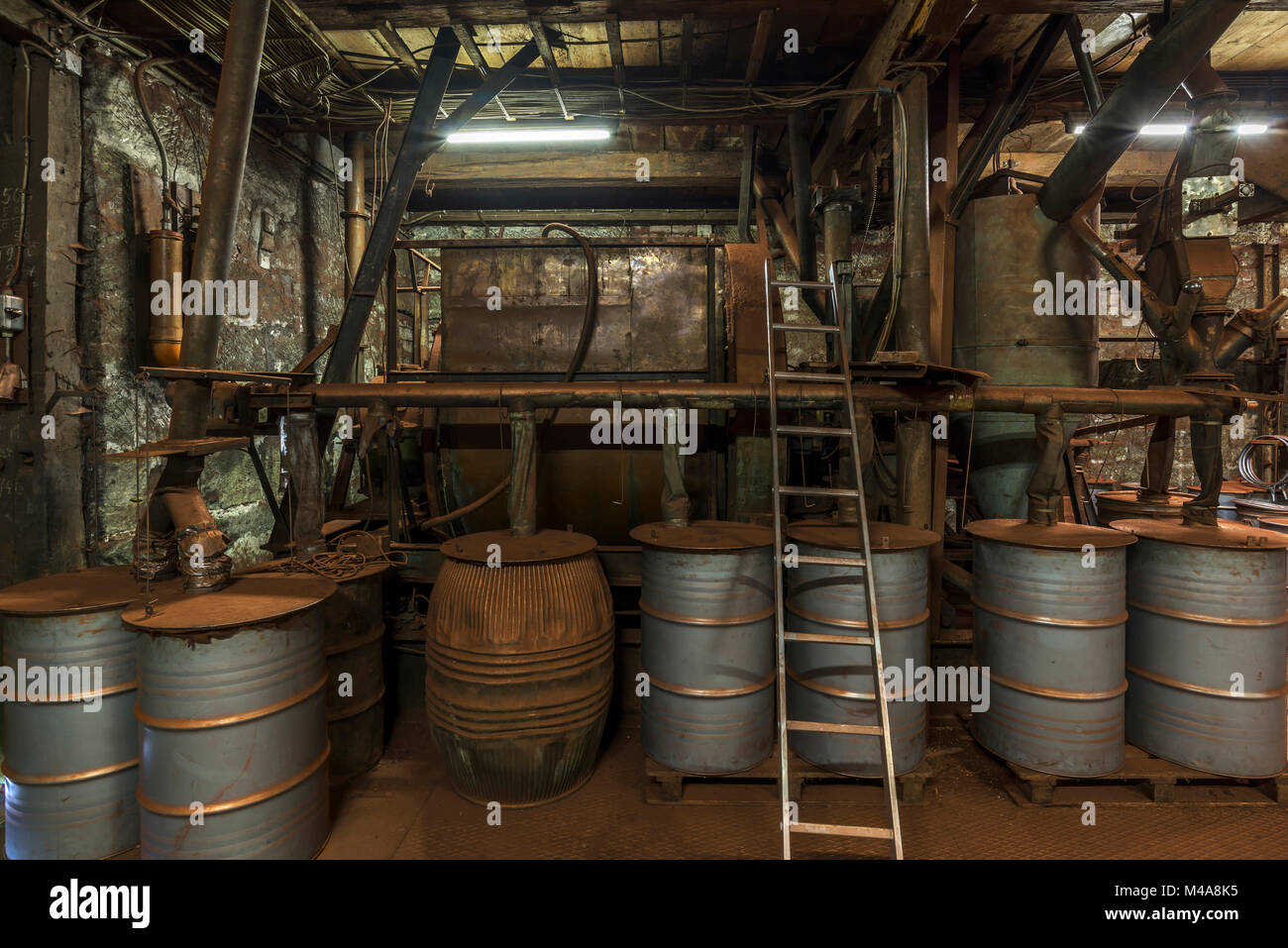 Production room for bronze powder with barrels and machines in a ...