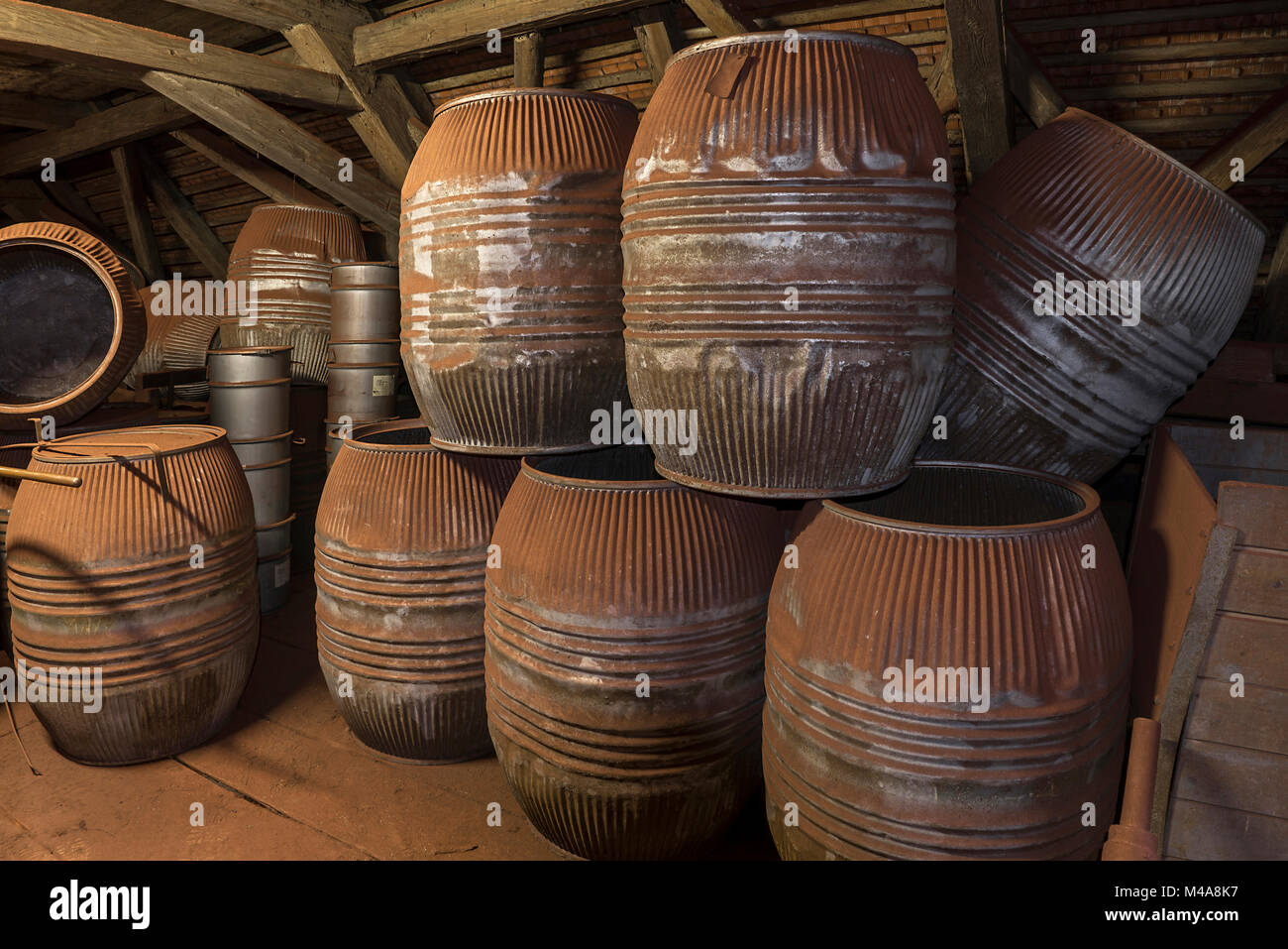 Stacked old barrels covered with bronze dust,historical metal powder ...