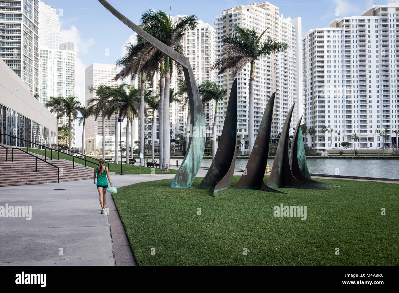 Woman walking along waterfront path in downtown Brickell, Miami ...