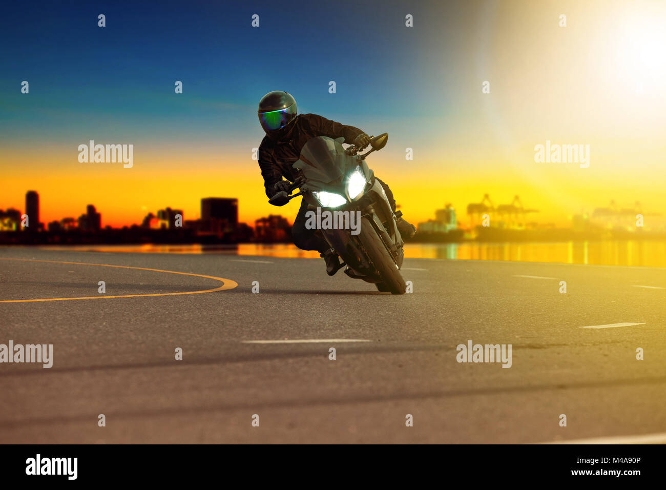 man riding sport motorcycle leaning in sharp curve with traveling scene ...