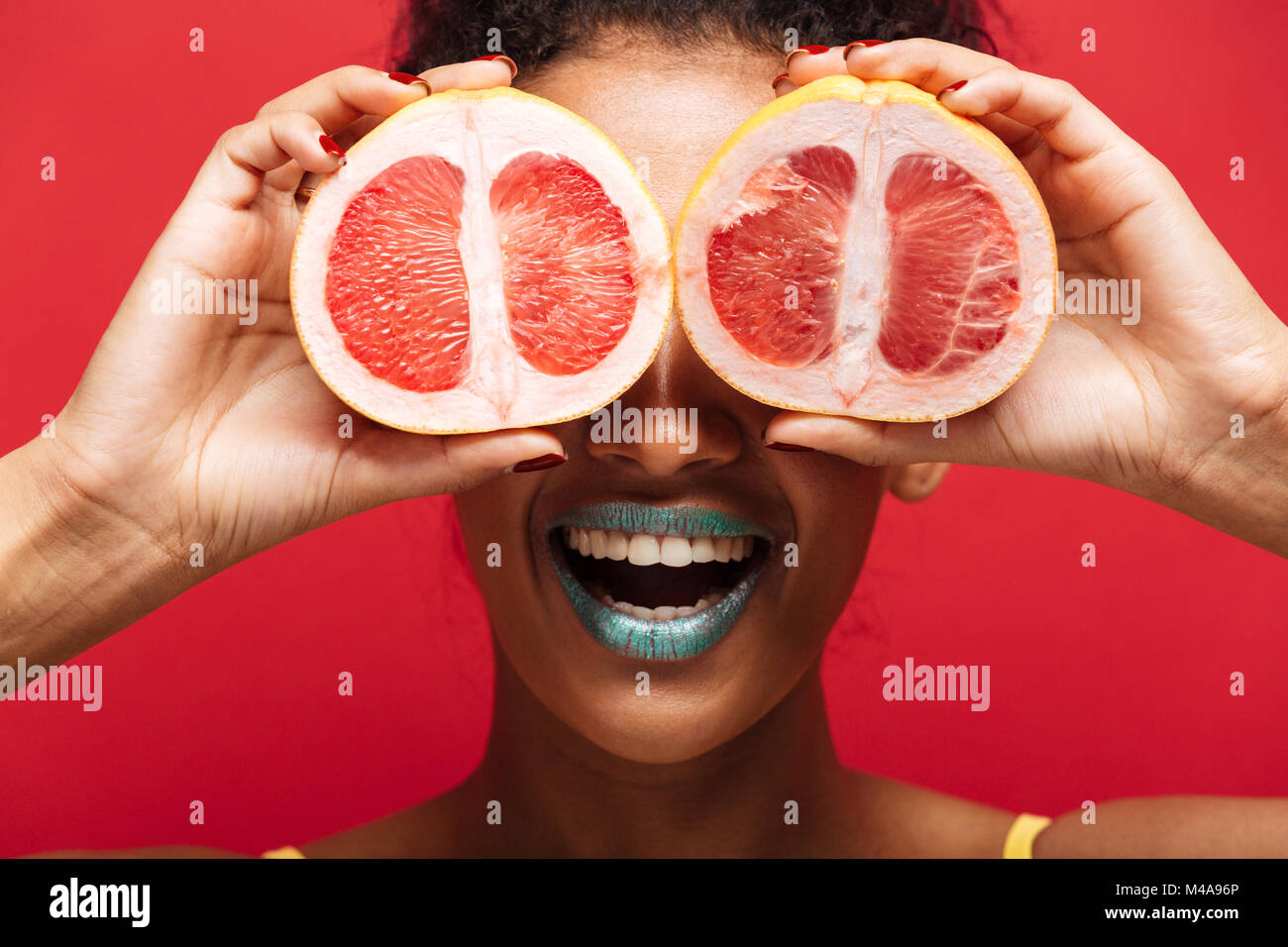 Close up food image of smiling afro american woman having fun covering ...