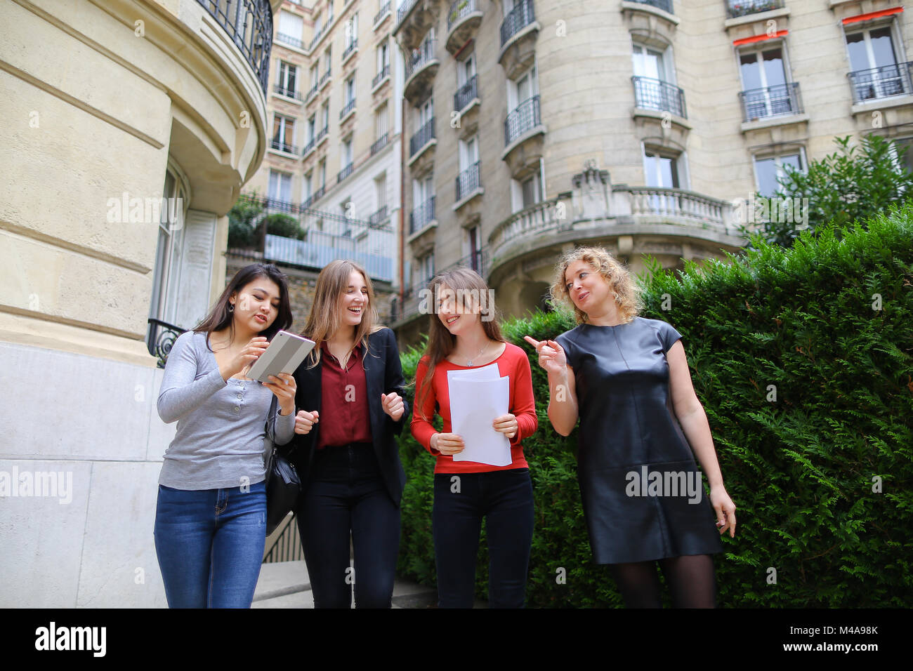Professor talking with new students near university building in Stock ...