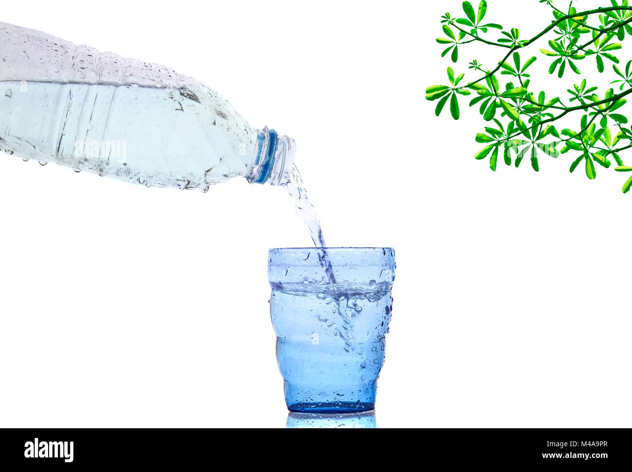 cool fresh drinking water bottle flowing to blue glass Stock Photo - Alamy