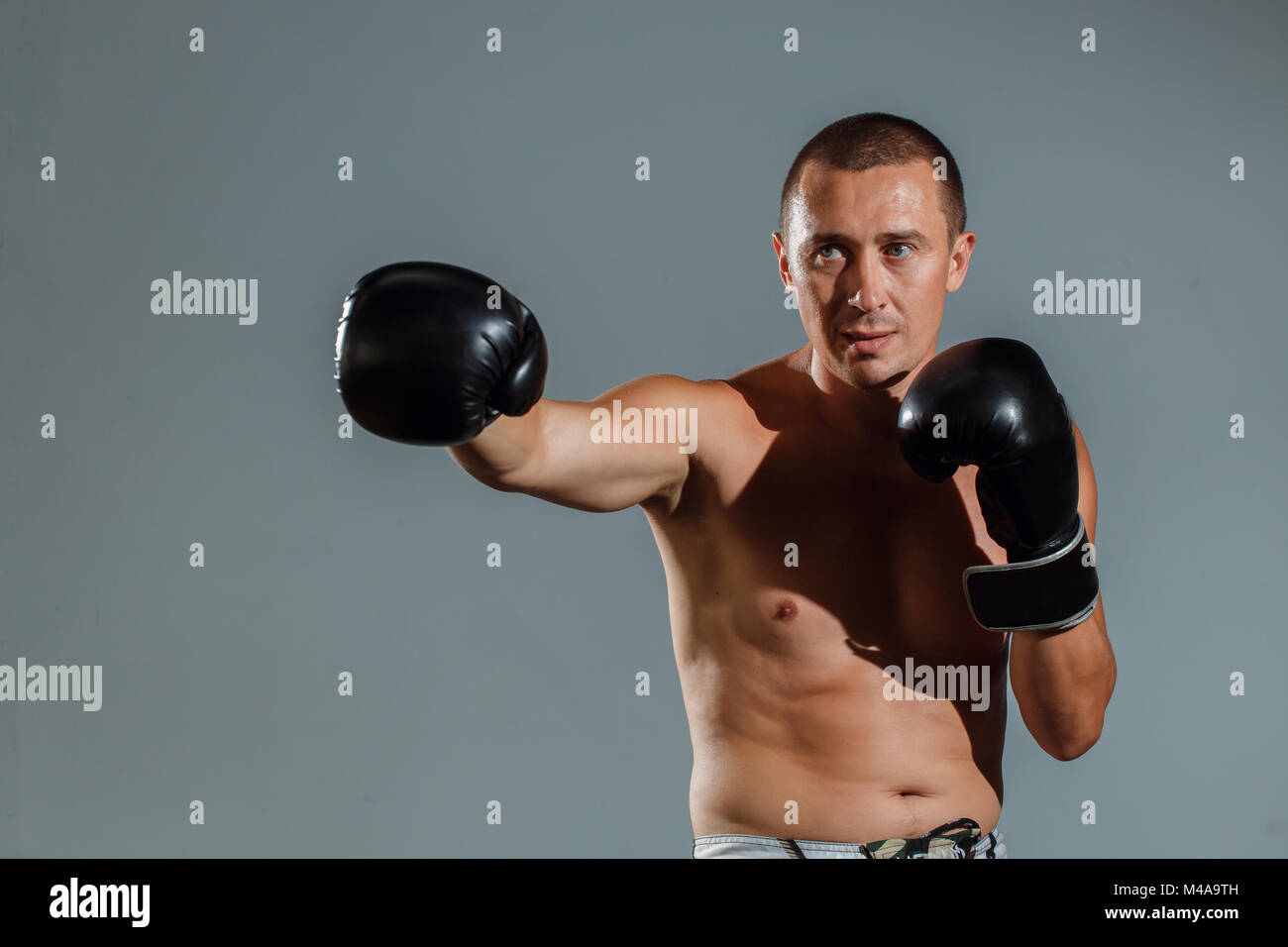 Sportsman muay thai boxer fighting in boxing cage. Sport concept Stock ...