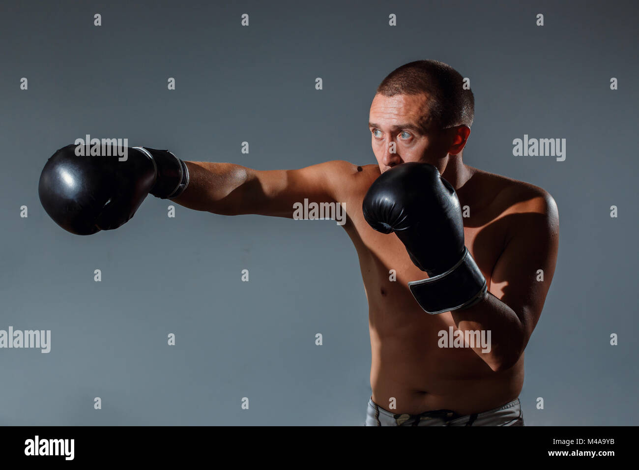 Boxing fighter trainning indoor on grey background Stock Photo - Alamy