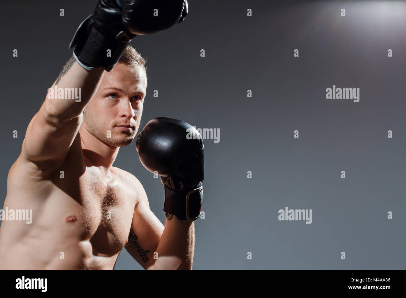 Sporty man during boxing exercise making direct hit Stock Photo - Alamy