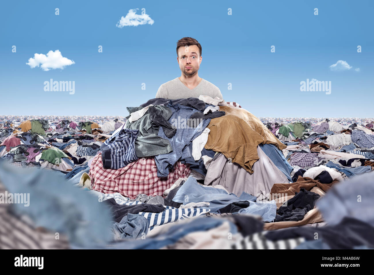 Man in a mess of laundry Stock Photo - Alamy