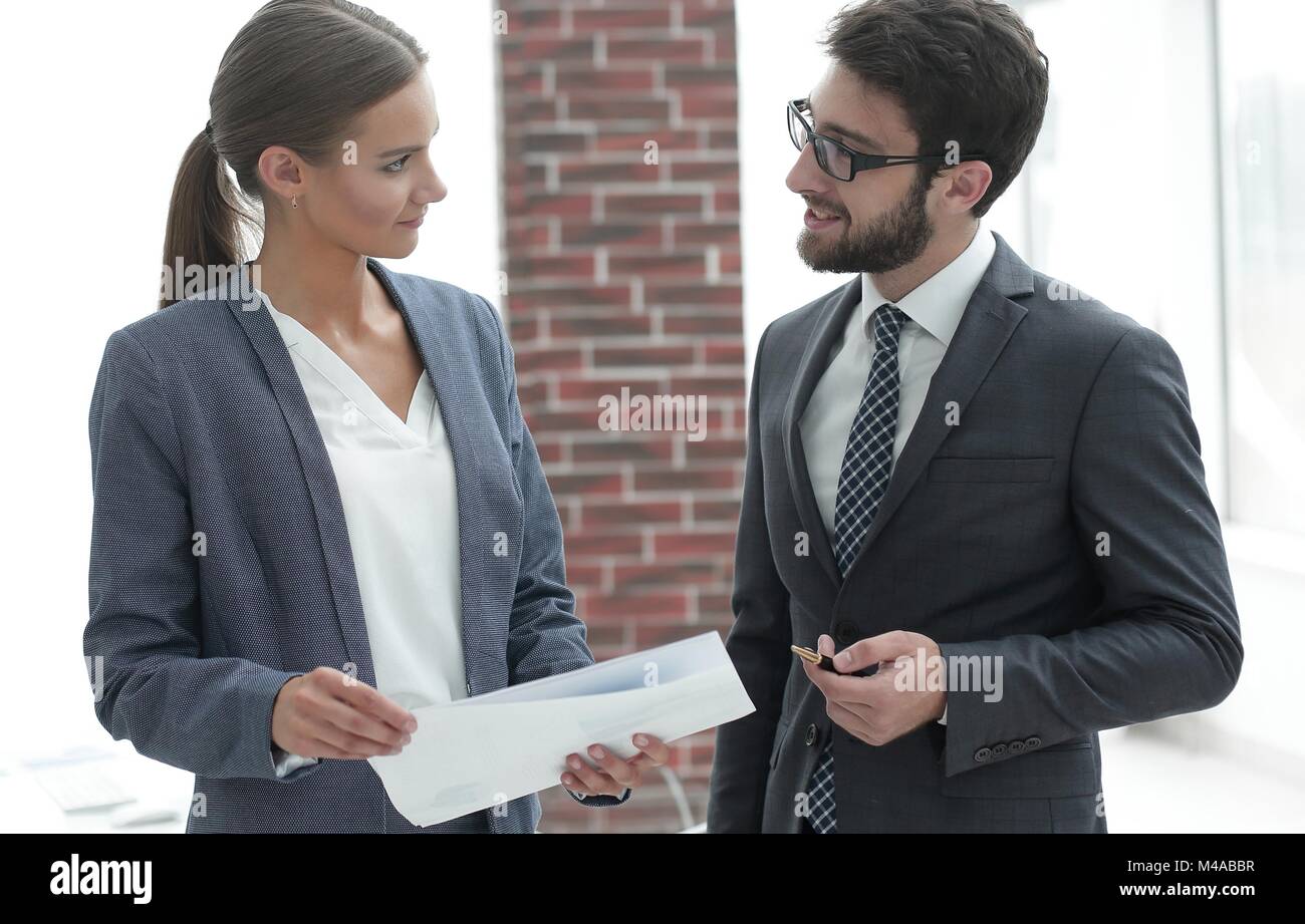 colleagues discussing business documents Stock Photo - Alamy