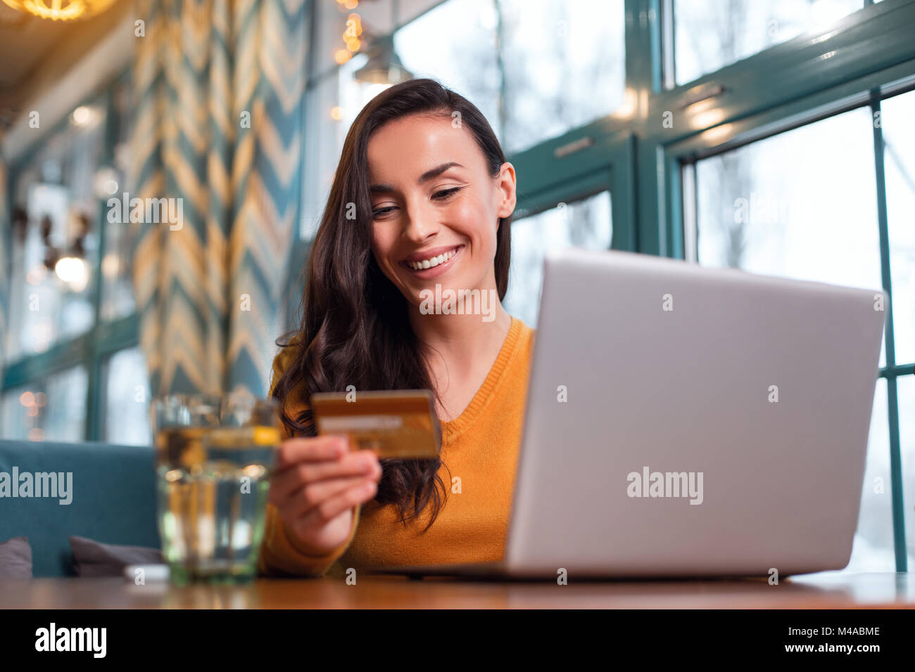 Irresistible positive woman using credit card Stock Photo - Alamy Irresistible positive woman using credit card Stock Photo - Alamy