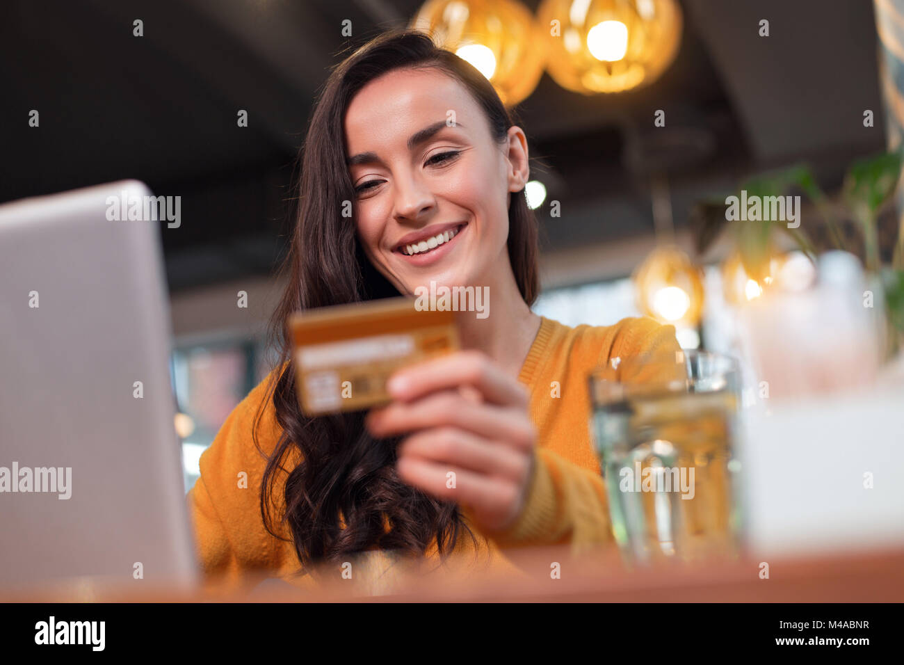 Appealing happy woman paying through Internet Stock Photo - Alamy