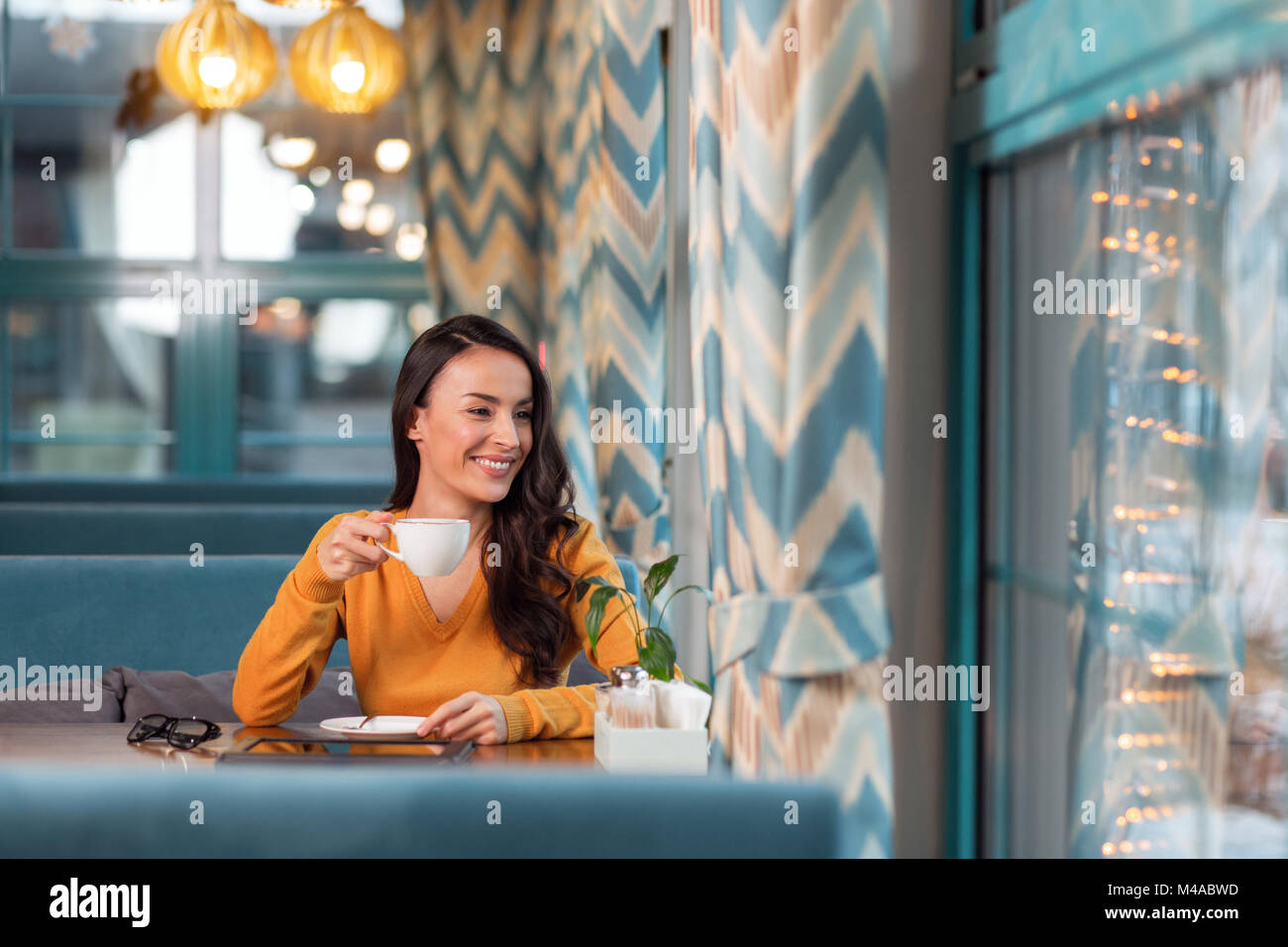 Beautiful happy businesswoman taking a rest Stock Photo - Alamy