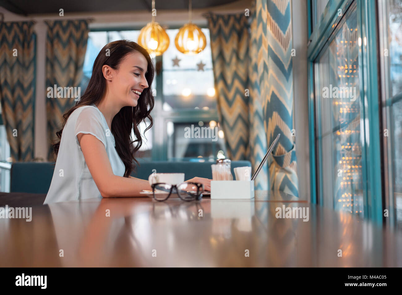 Charming female freelancer concentrating on work Stock Photo - Alamy