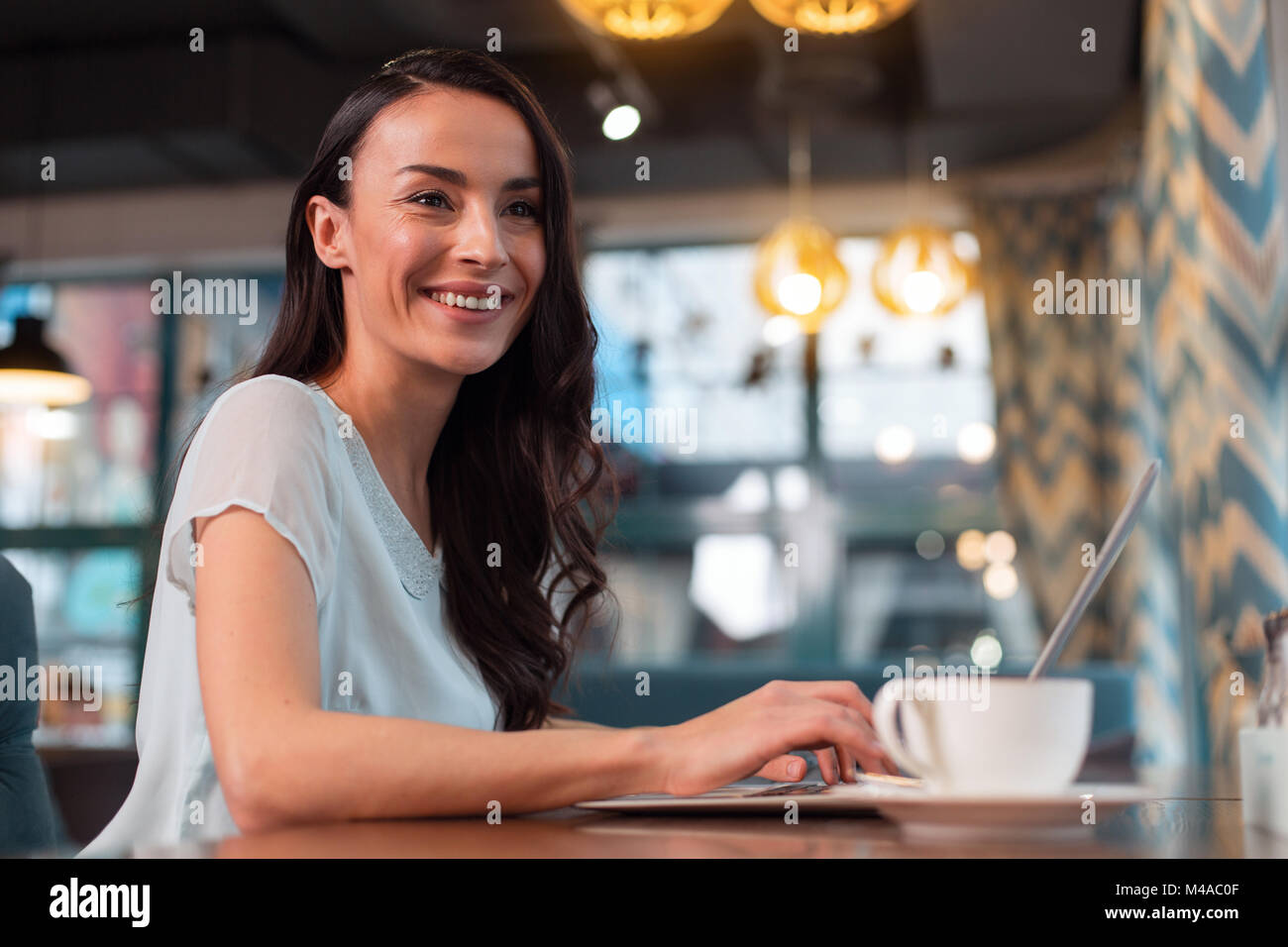 Cheerful female freelancer performing project Stock Photo - Alamy