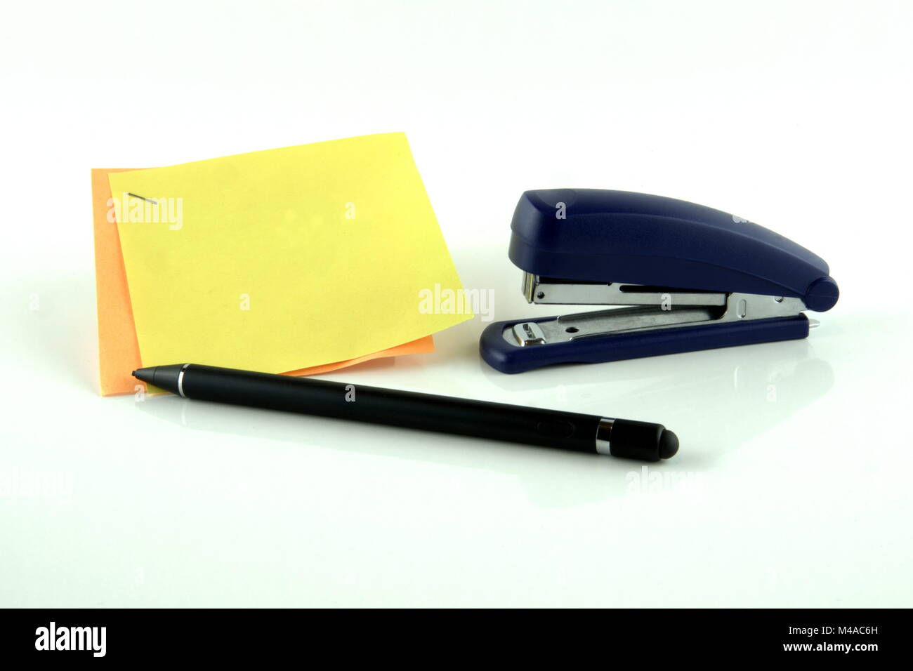 Sticky notes with pen and stapler isolated against a white background ...