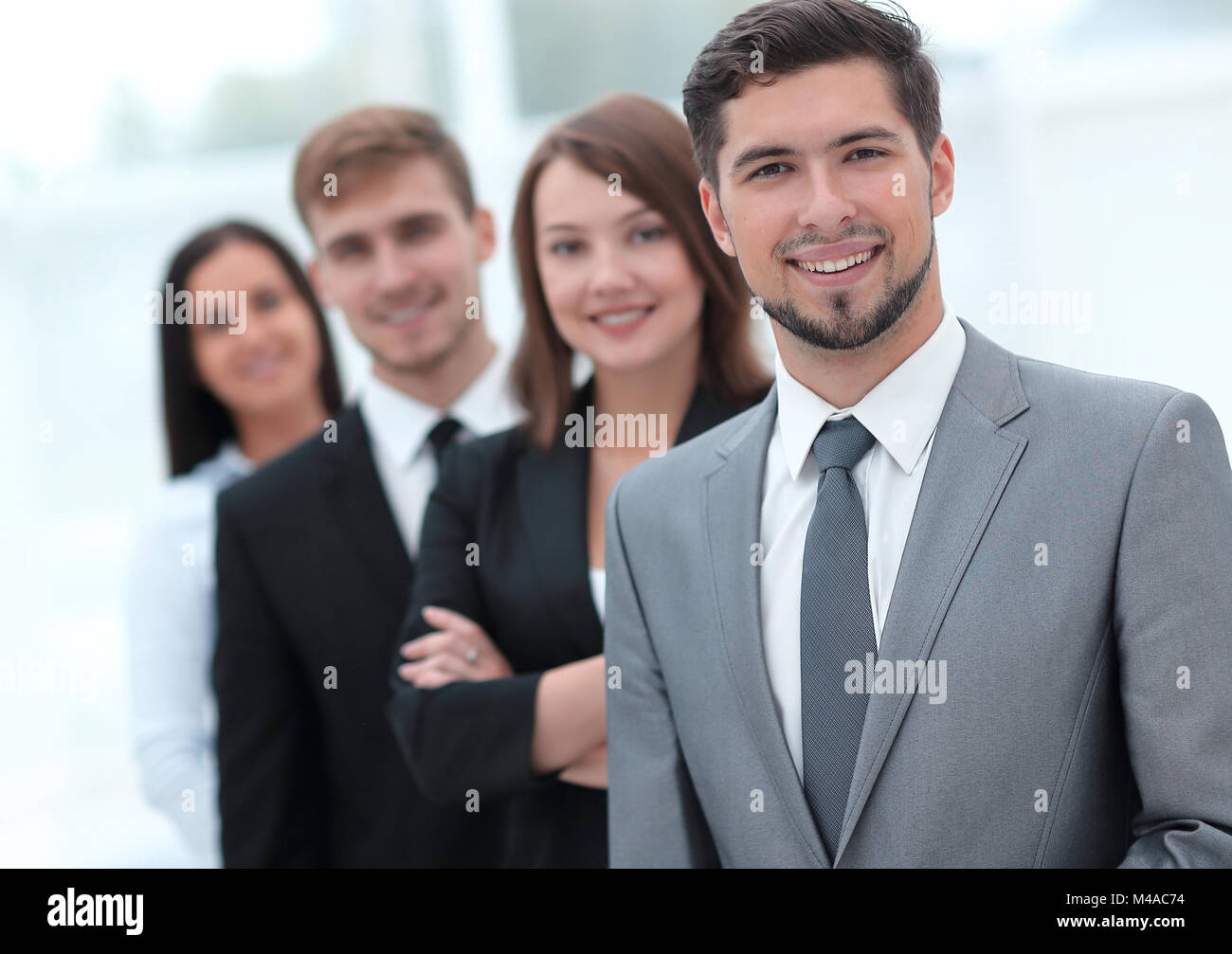 leader and the business team standing one behind the other Stock Photo ...