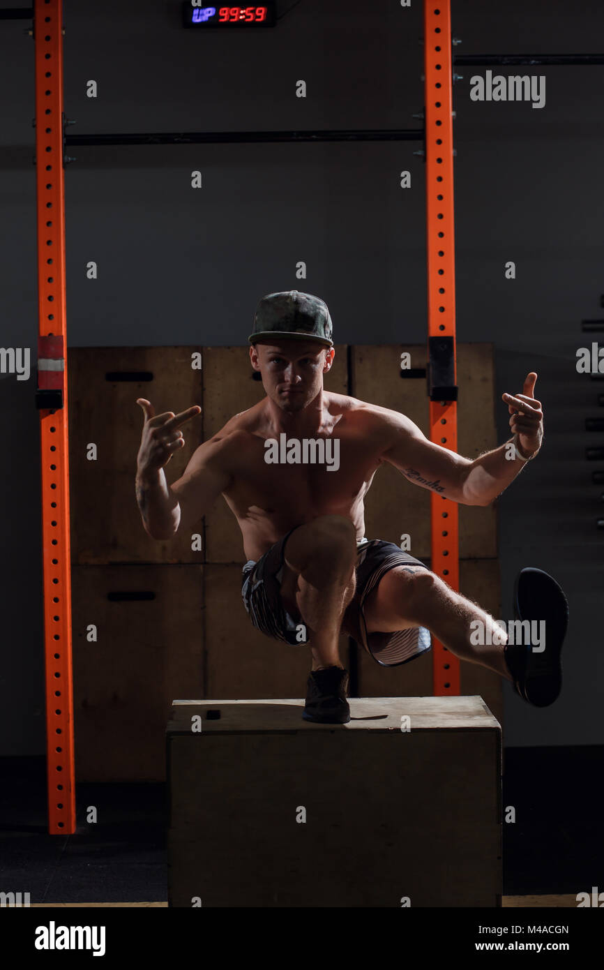 Brutal tattooed calisthenics coach shows exercise moves one leg squat ...