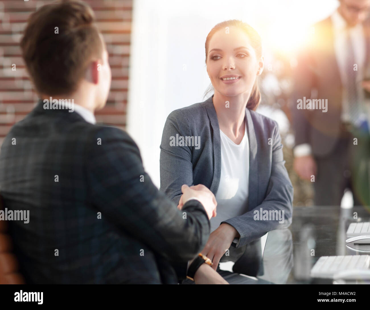 handshake Manager and the client in the office Stock Photo - Alamy