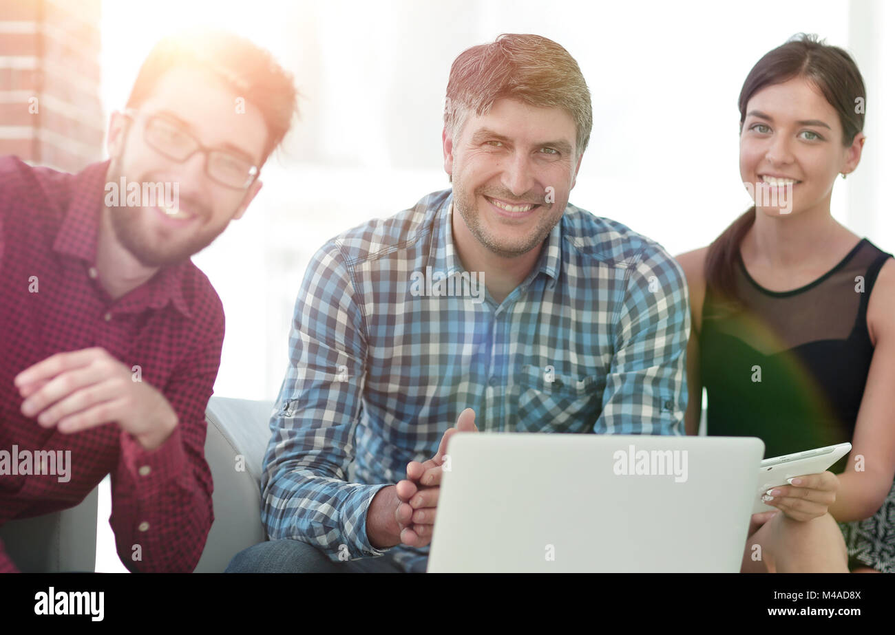 Group of young colleagues using laptop at office Stock Photo - Alamy