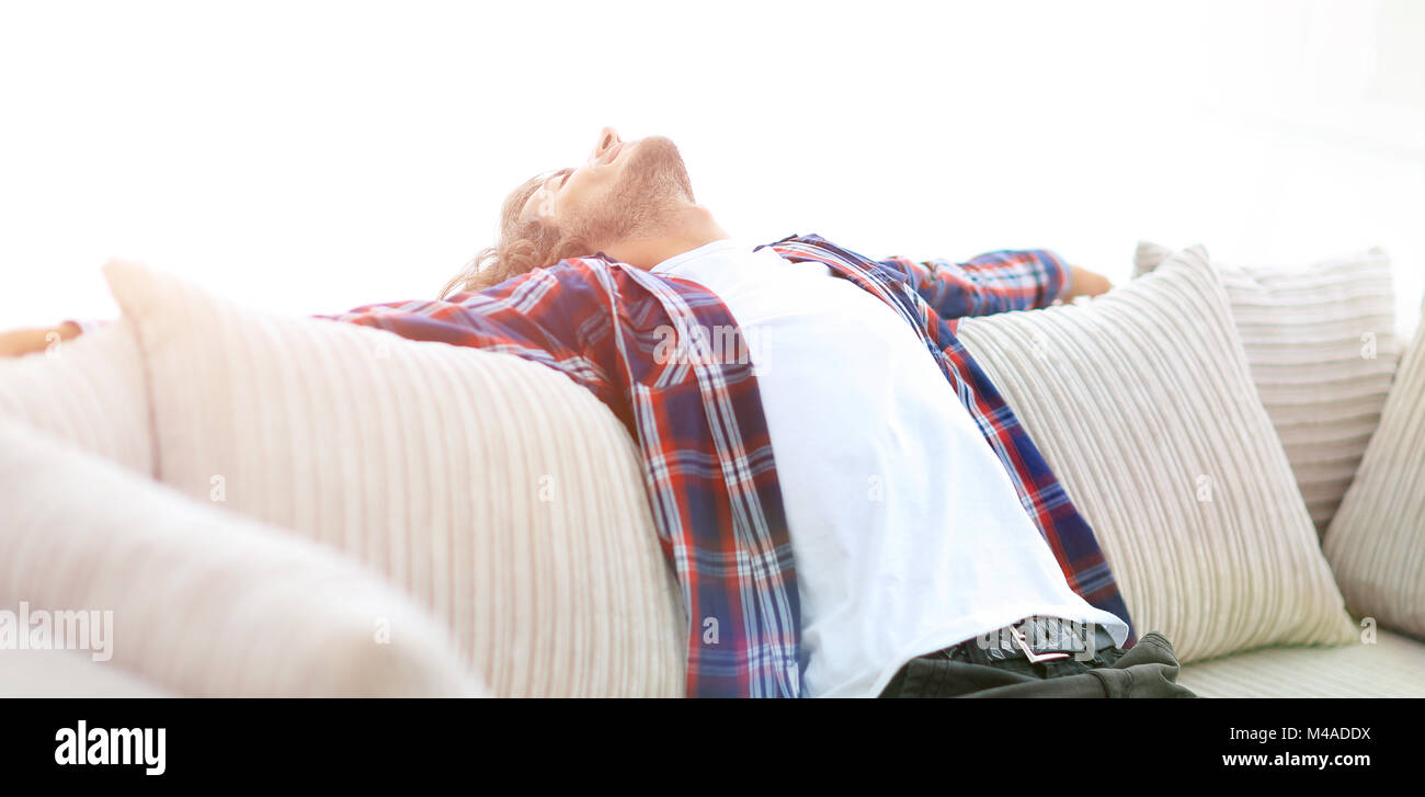 handsome successful guy resting on the couch Stock Photo - Alamy