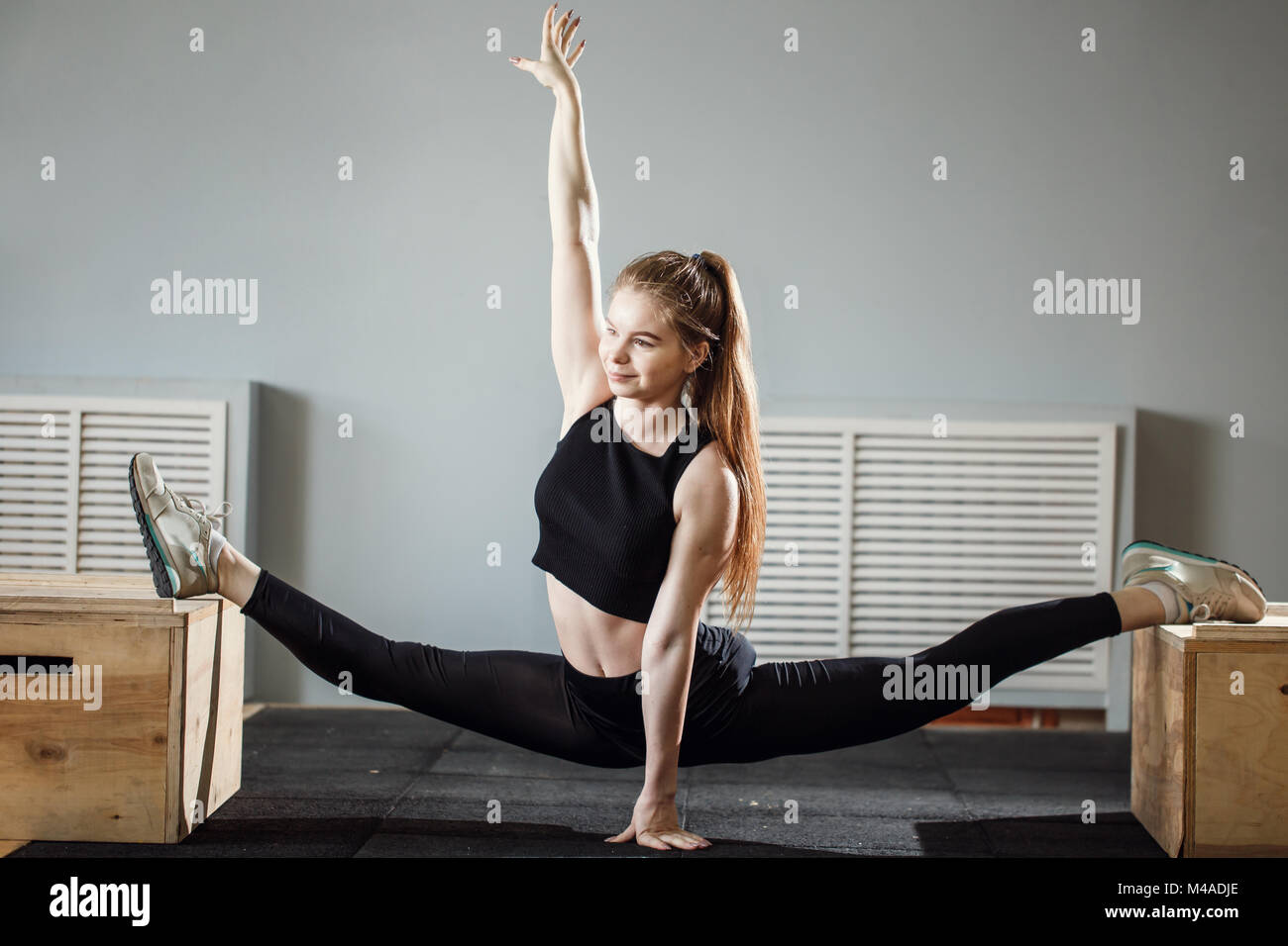 Young yogi woman practicing yoga concept, doing advanced splits ...