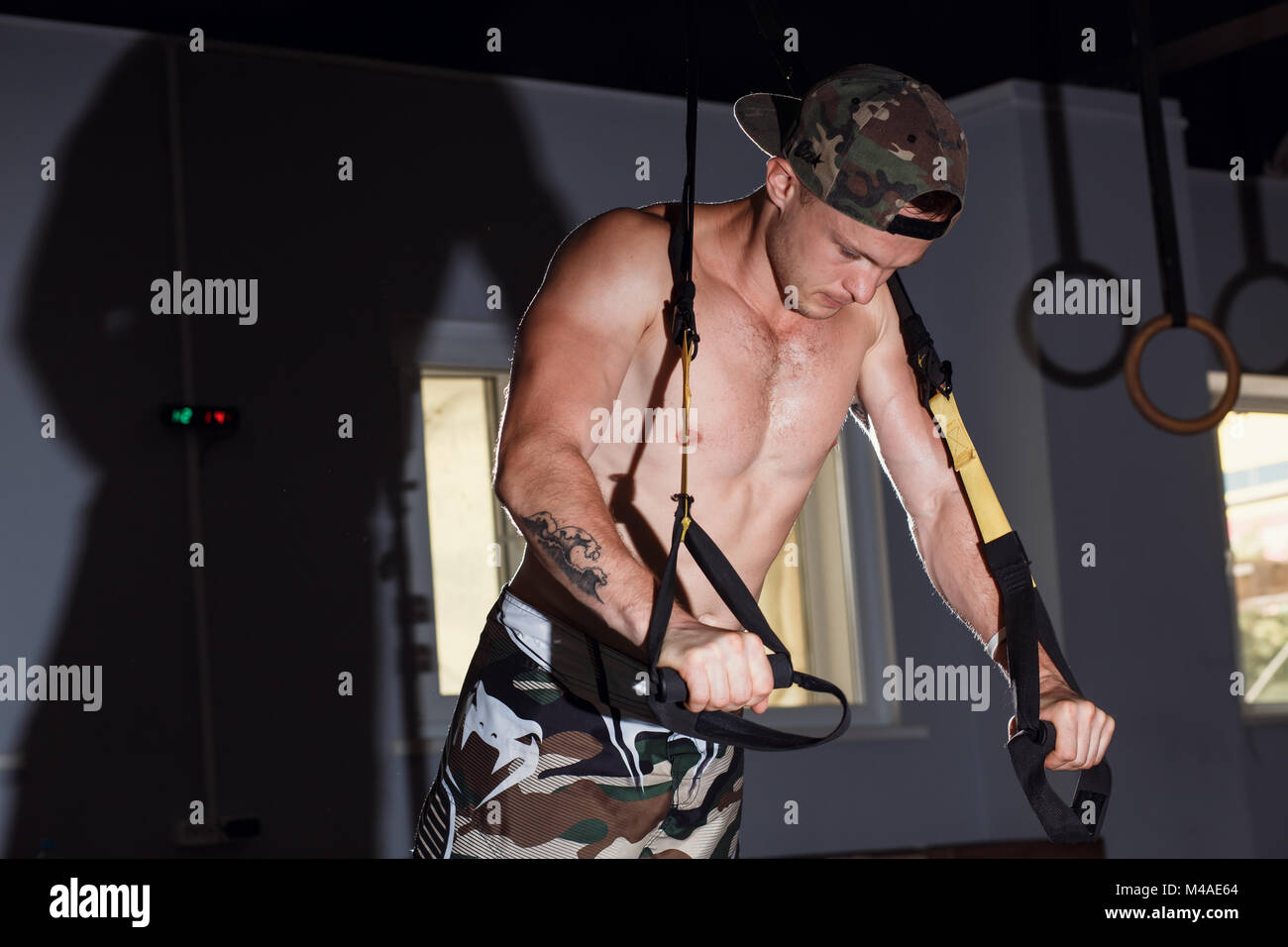 TRX training. Crossfit instructor at the gym doing TRX Excersise Stock ...