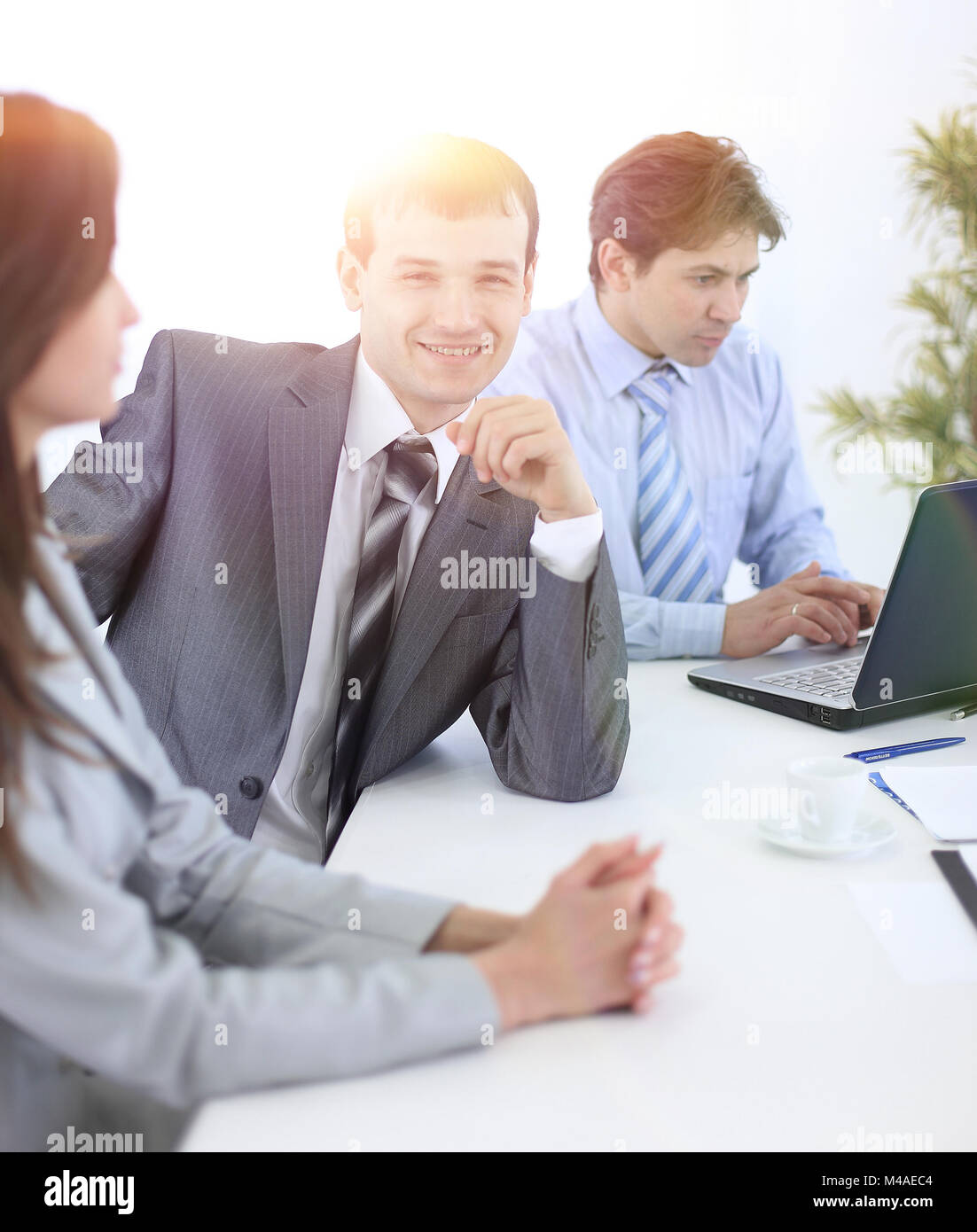 Manager and colleagues in the workplace Stock Photo - Alamy