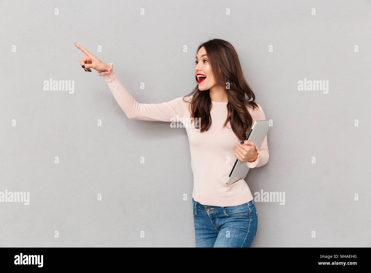 Half-turn photo of charming woman with long brown hair holding silver ...