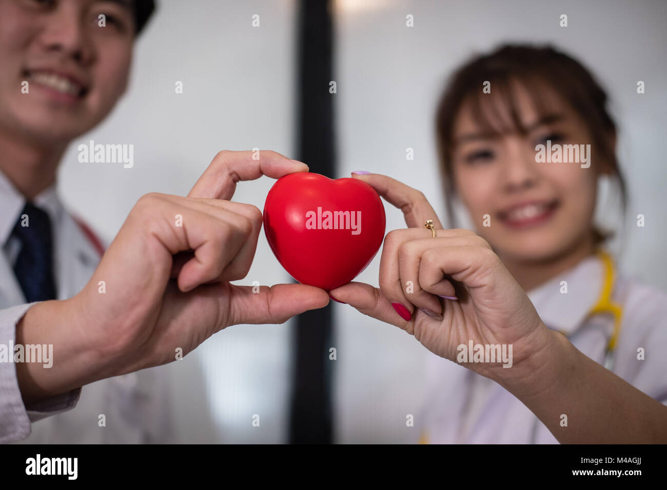 Smiling doctor man red heart medicine hi-res stock photography and ...