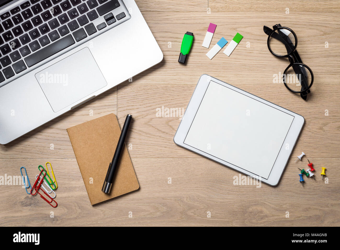 Blank white tablet with copy space for writing a message lying on ...
