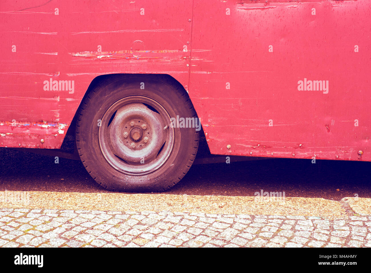 red scratched vintage bus fragment with focus on wheel Stock Photo - Alamy