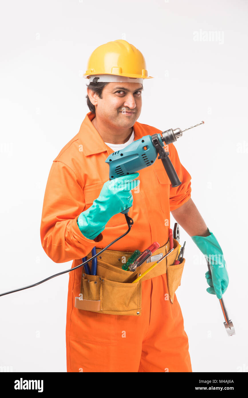 Indian electrician engineer in action with wire cutter, drilling ...