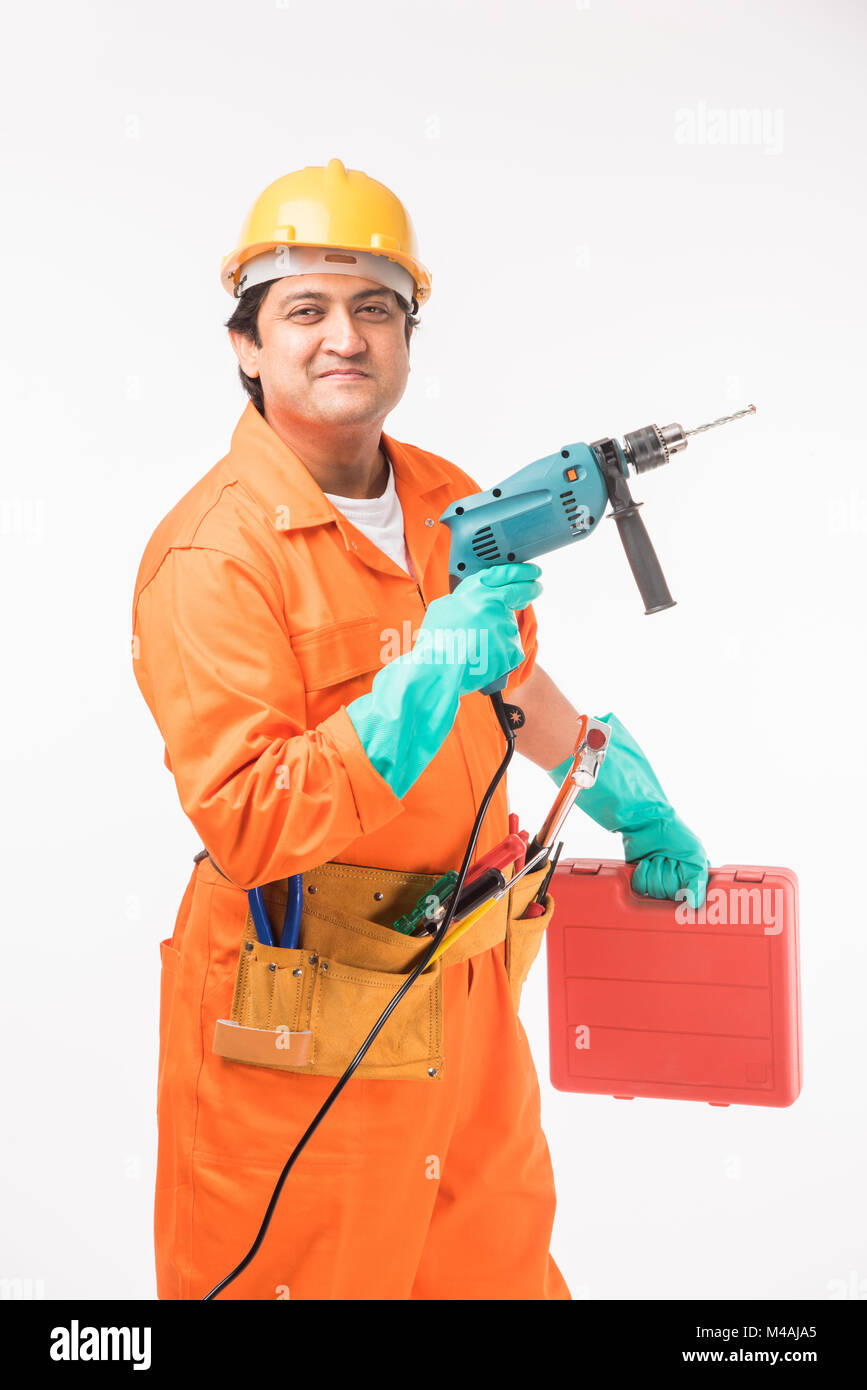 Indian electrician engineer in action with wire cutter, drilling ...