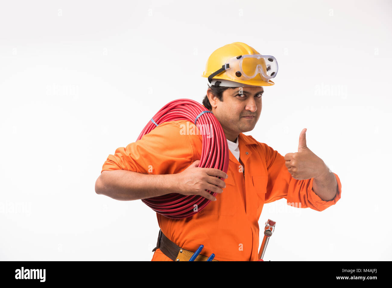 Indian electrician engineer in action with wire cutter, drilling ...