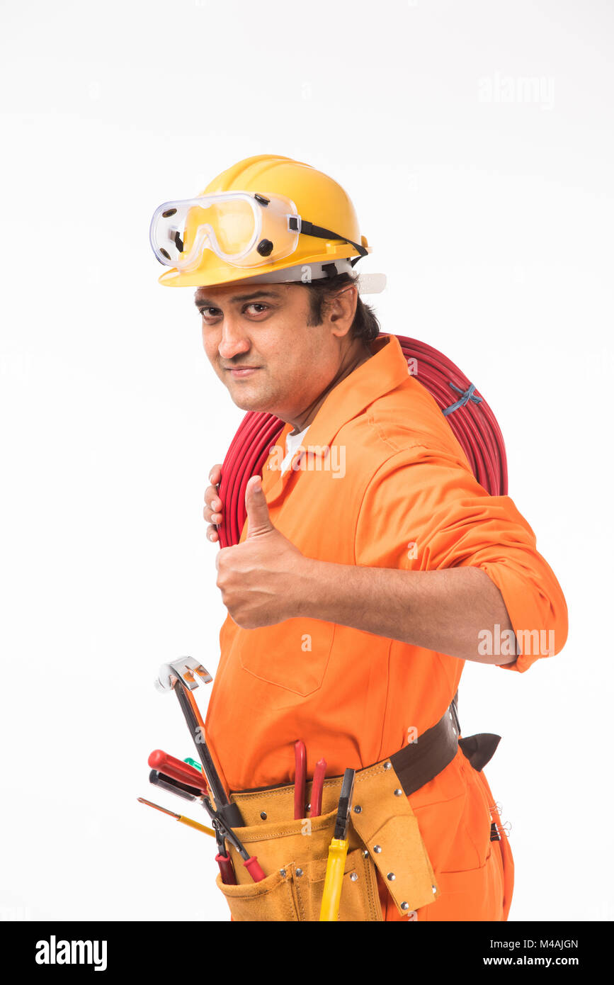 Indian electrician engineer in action with wire cutter, drilling ...