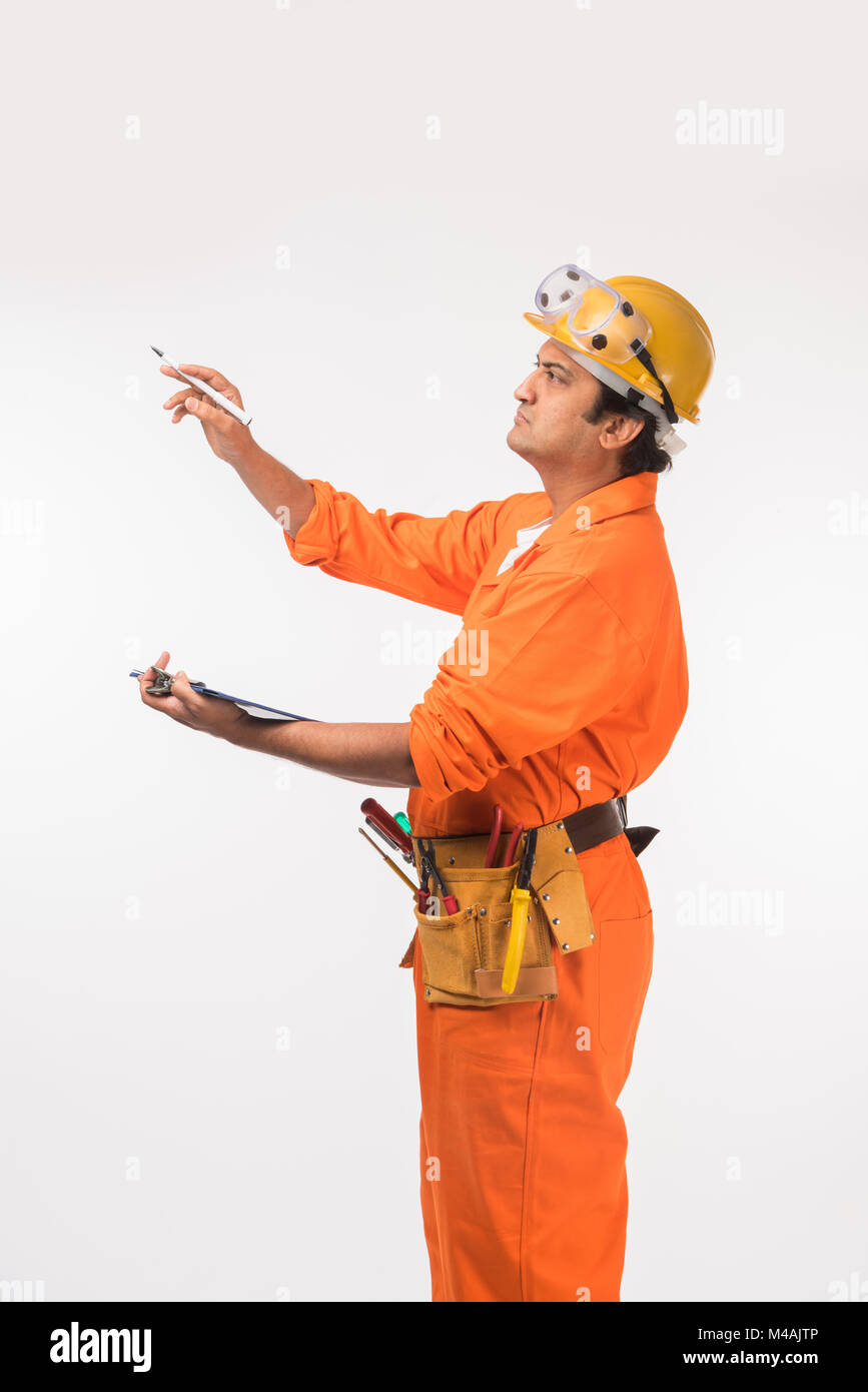 Indian electrician engineer in action with wire cutter, drilling ...